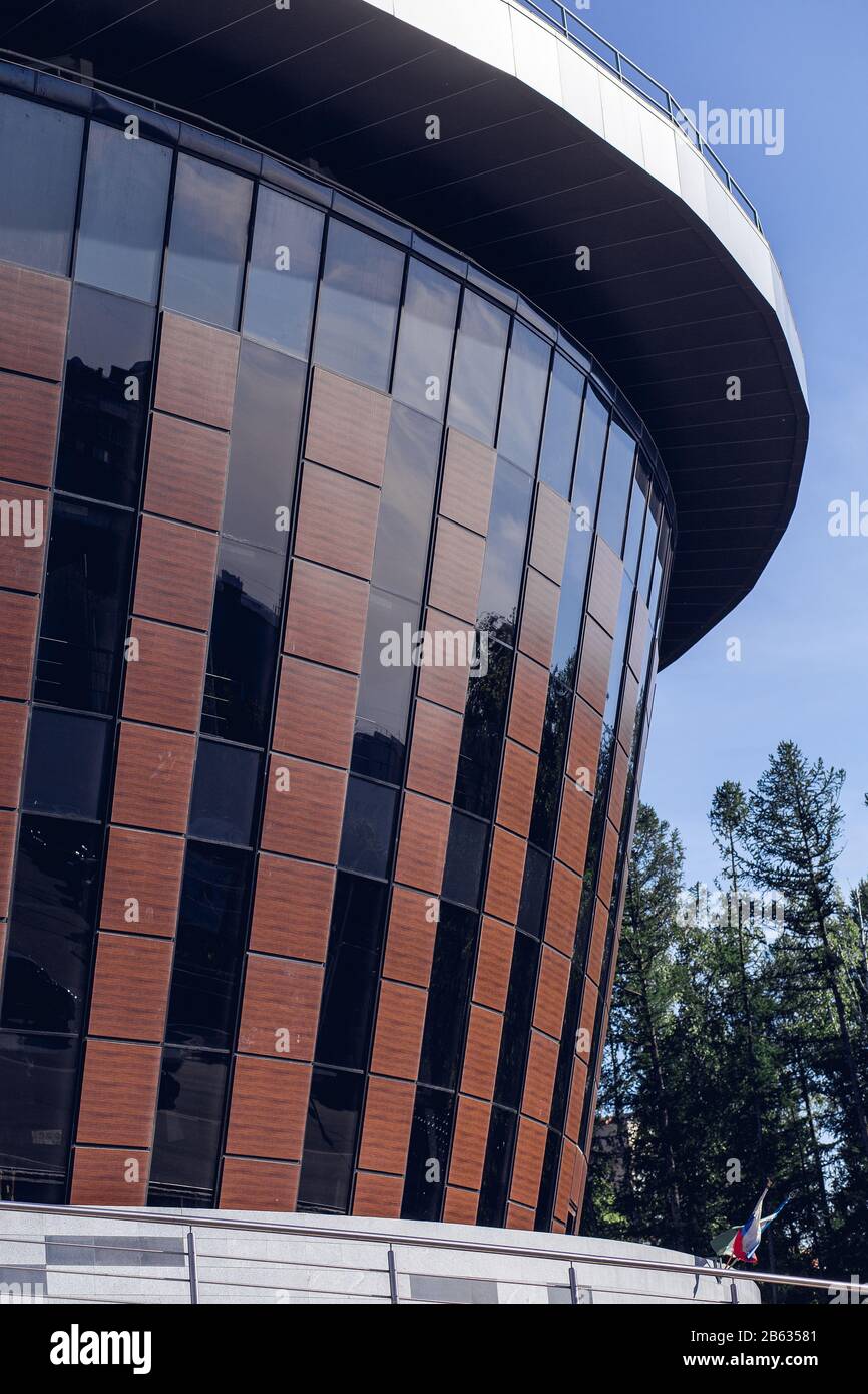 round glass multistory building blue sky background Stock Photo - Alamy