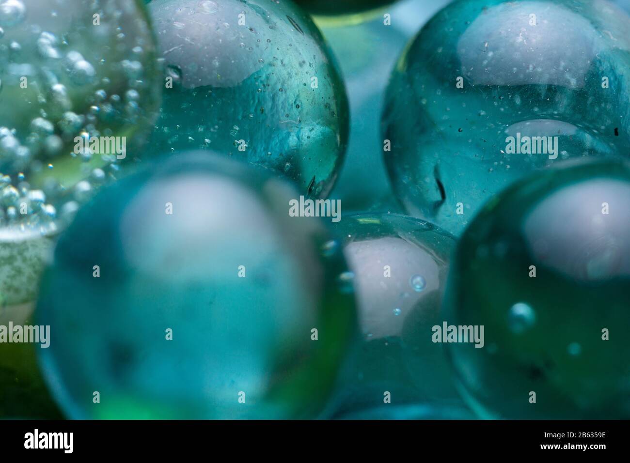 Frame filled with close up macro view of glass sphere marbles with air ...