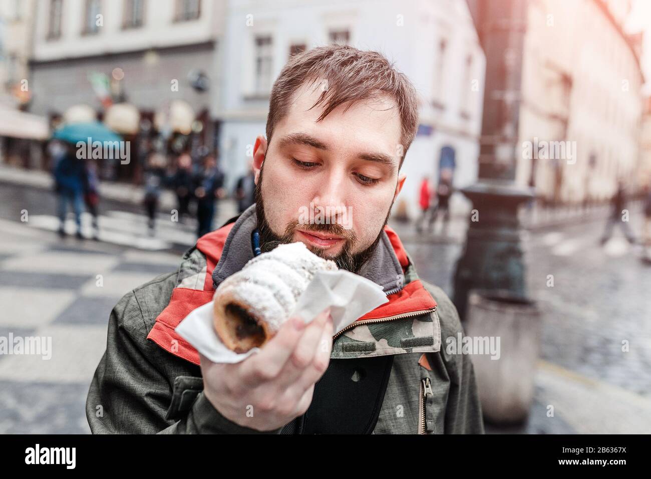 Man eating snack walking hi-res stock photography and images - Alamy