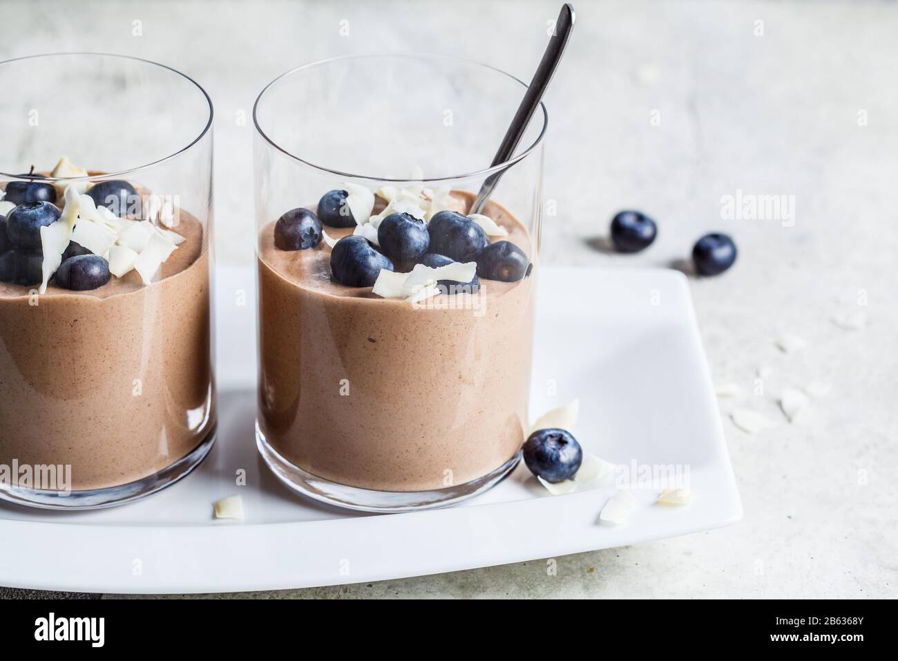 Chocolate mousse smoothie with berries and coconut in a glass for ...