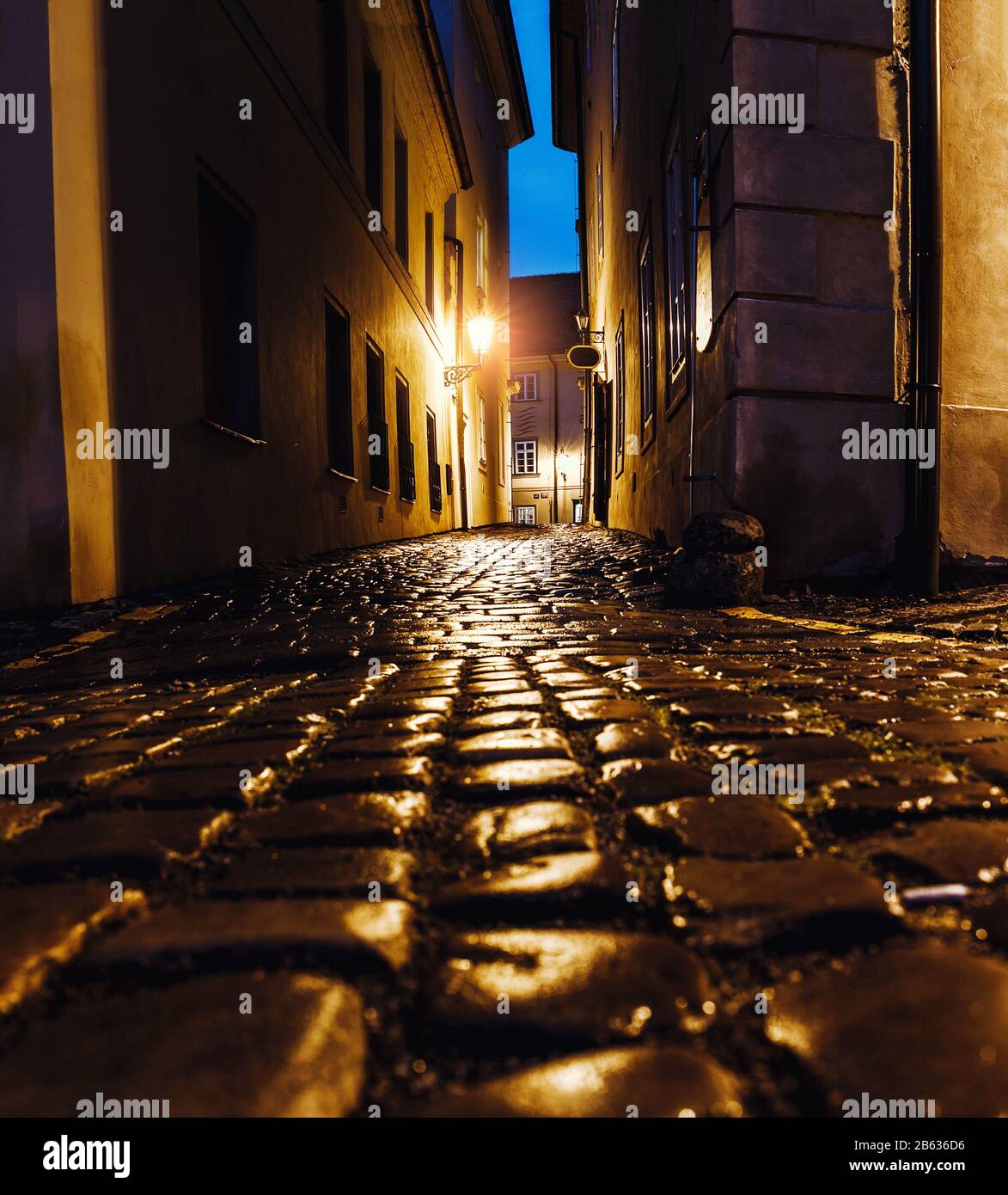 mysterious narrow alley with lanterns and pavement stones in Prague ...