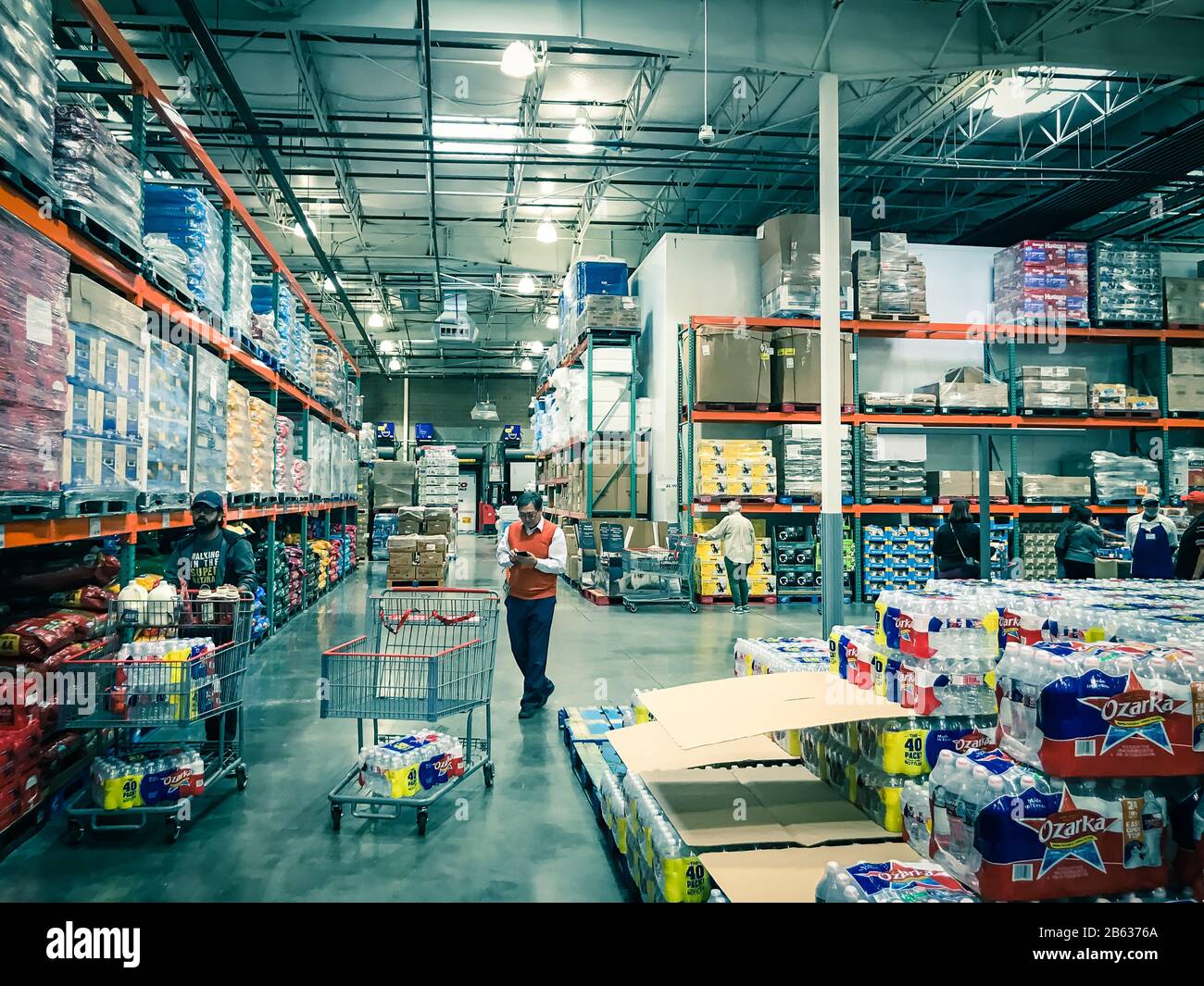Shoppers stocking bottled water at Costcow Warehouse store Stock Photo ...