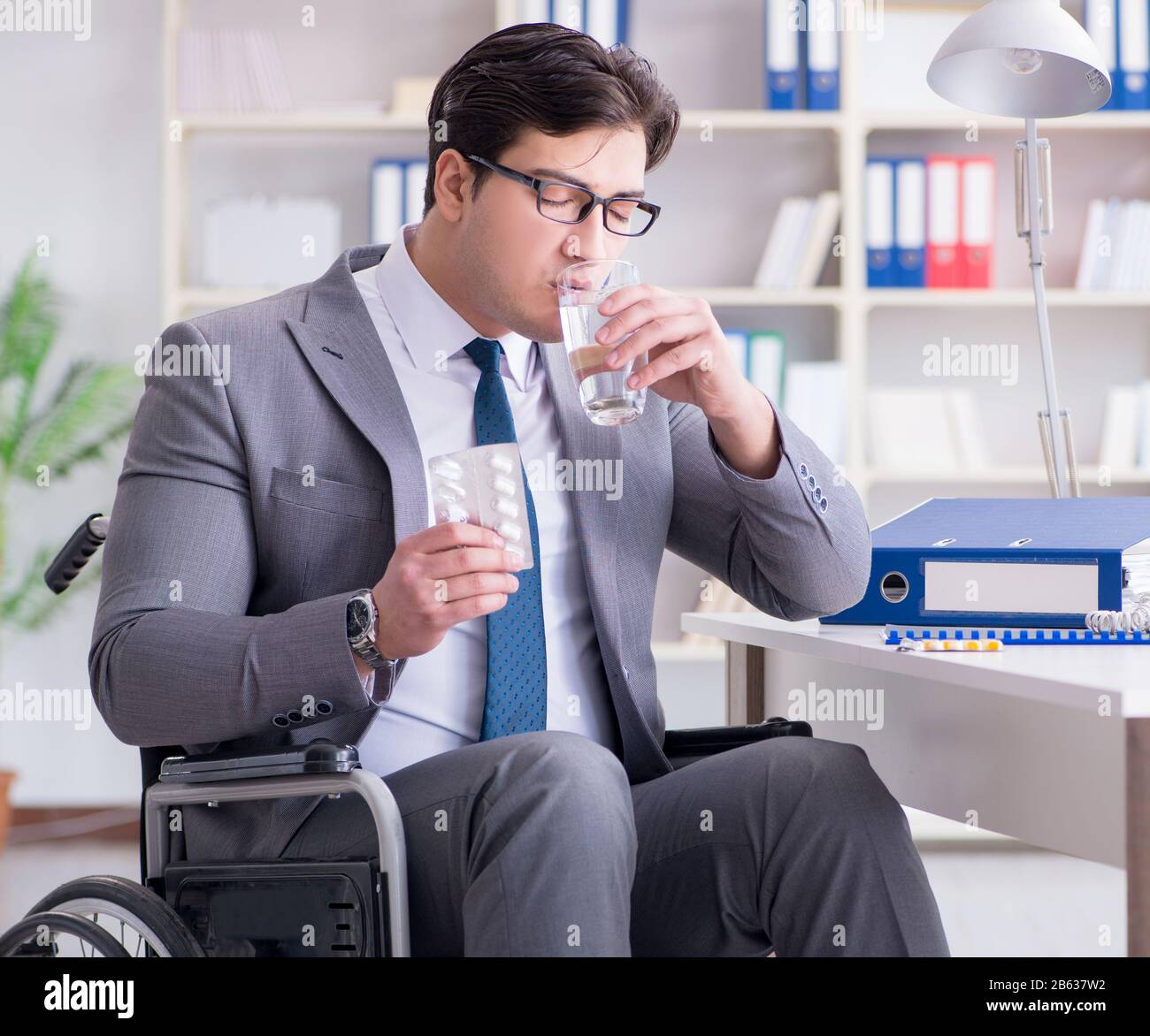 The disabled businessman working in the office Stock Photo - Alamy