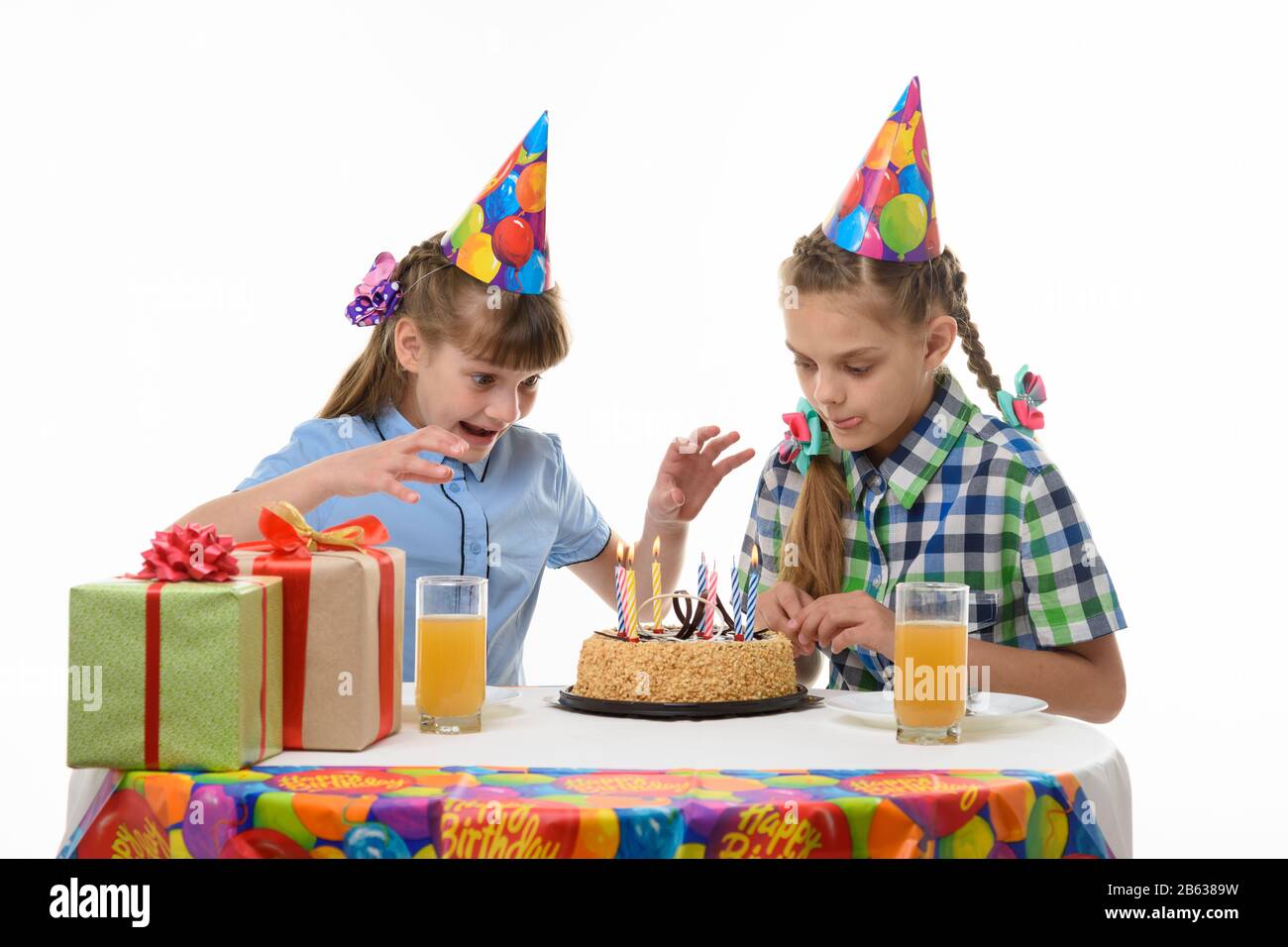 Two girls want sweet and are happy to throw themselves on a birthday ...