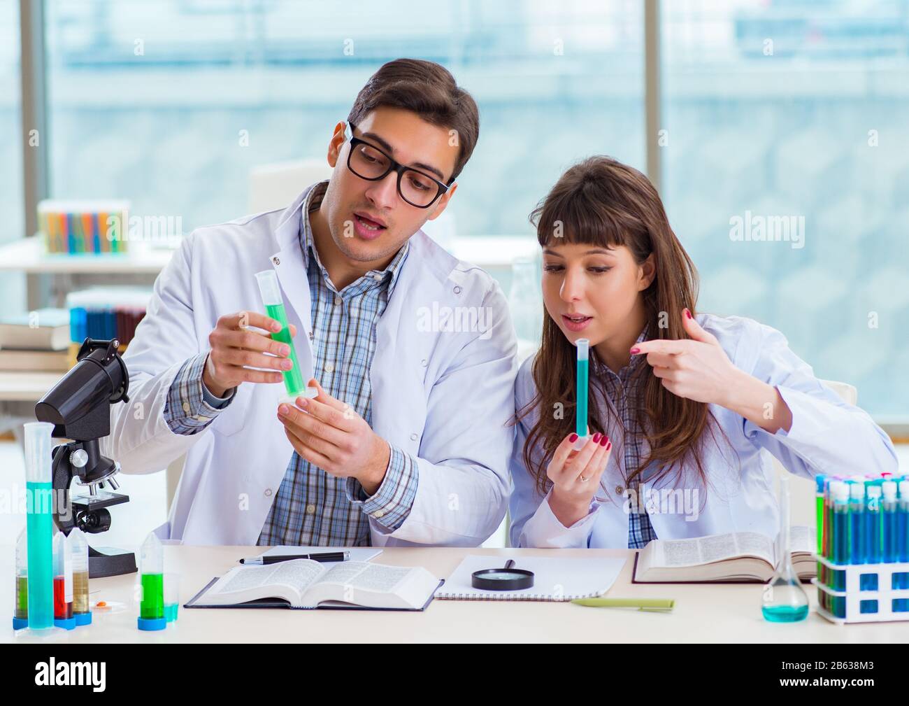 The two chemists working in lab experimenting Stock Photo - Alamy