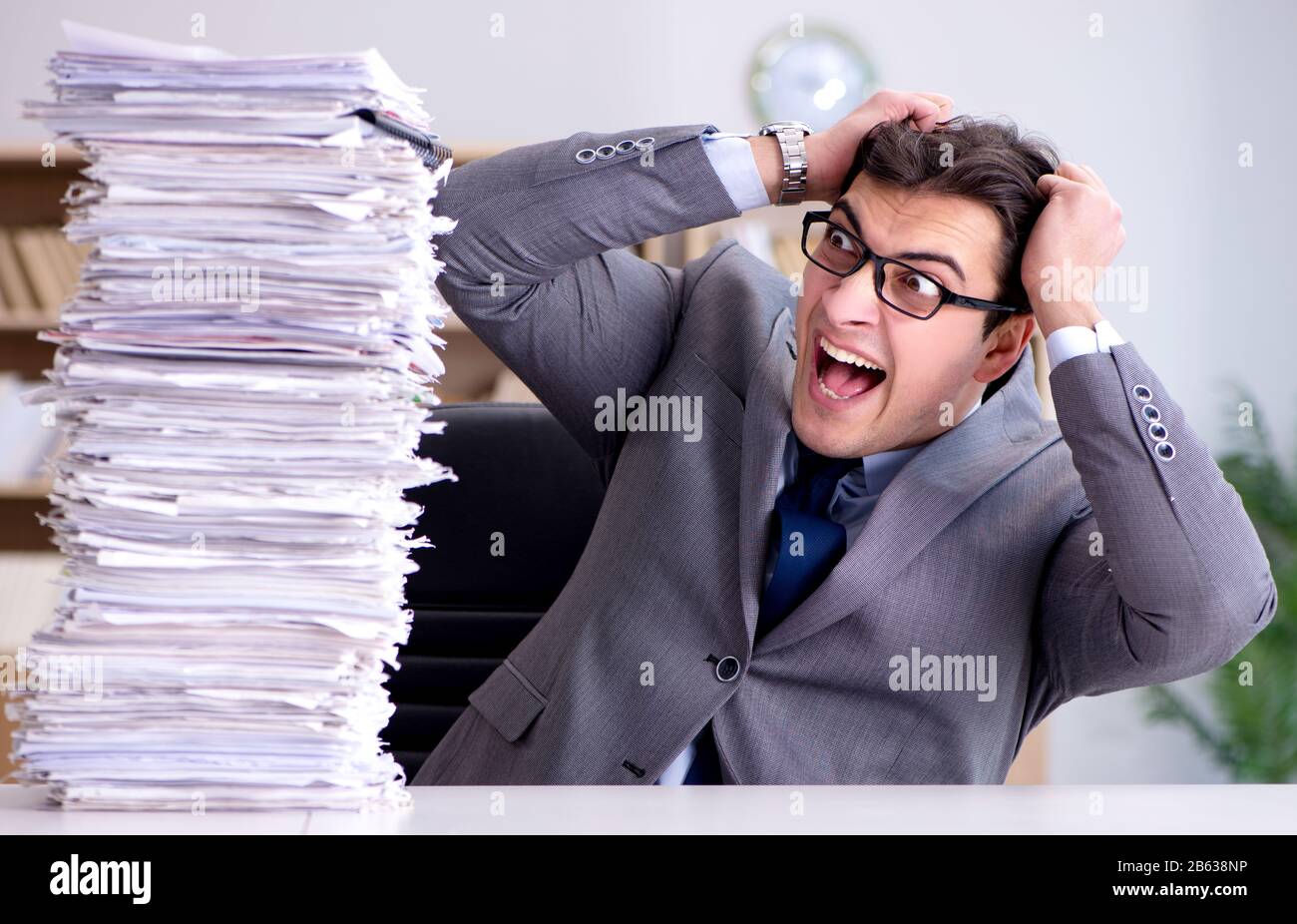 The businessman struggling to meet challenging deadlines Stock Photo ...