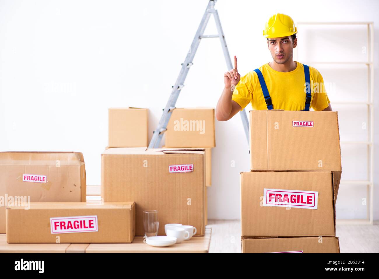 Young professional mover doing home relocation Stock Photo - Alamy