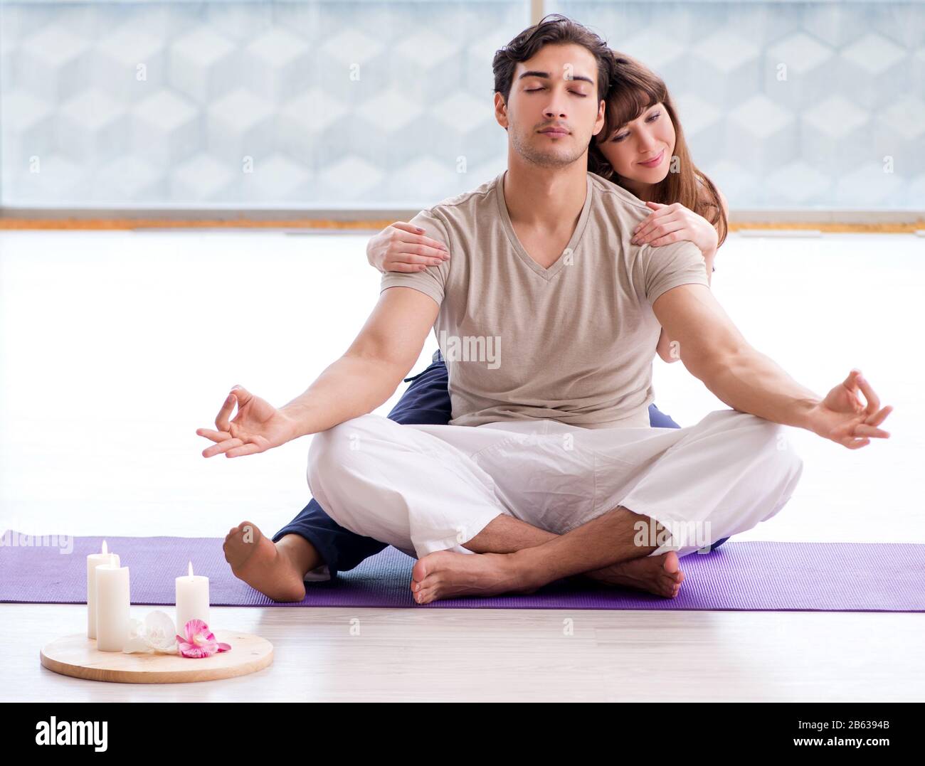The personal coach helping during yoga session Stock Photo - Alamy