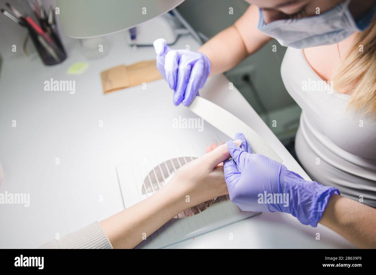 The master prepares the nails for manicure. Professional workplace ...