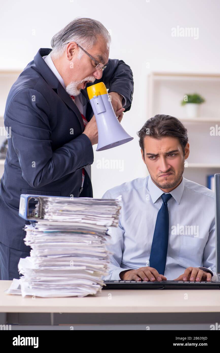 Old boss and young employee in the office Stock Photo - Alamy