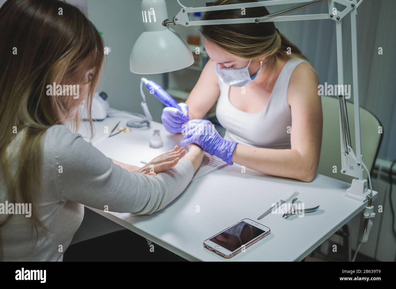 Professional manicure procedure. Beauty salon Stock Photo - Alamy