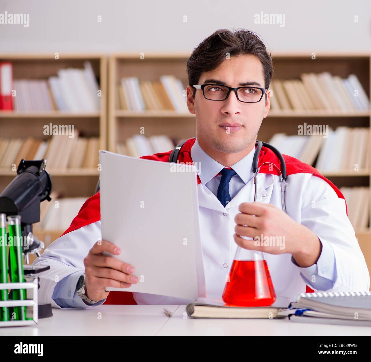 The superhero doctor working in the lab hospital Stock Photo - Alamy