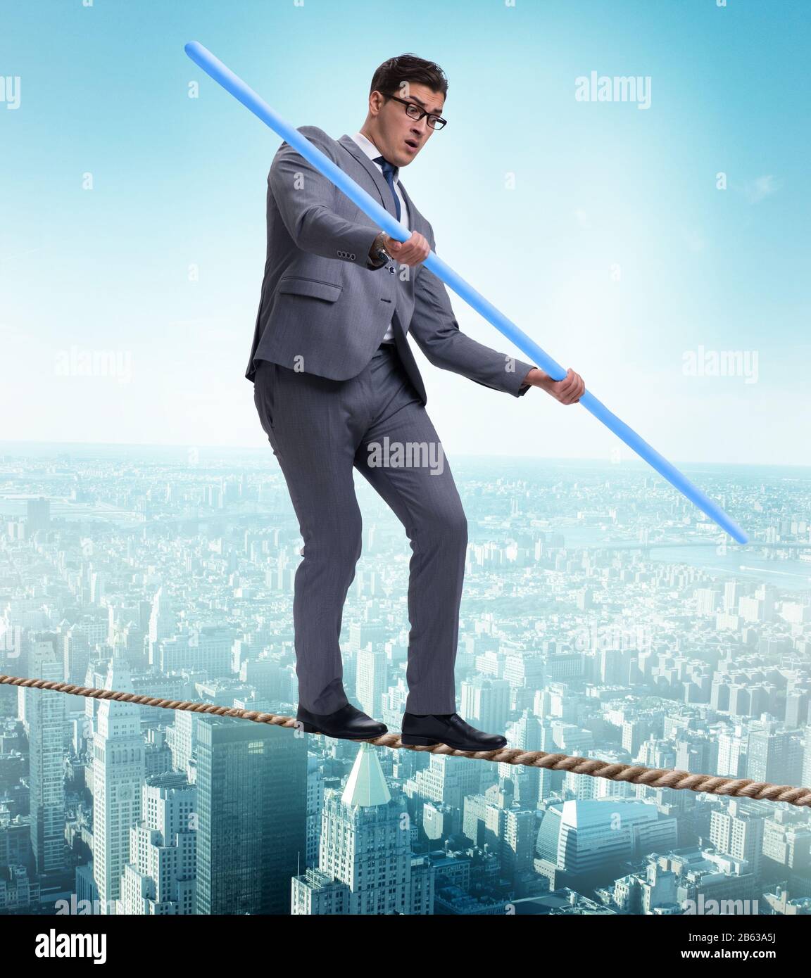 The businessman doing tightrope walking in risk concept Stock Photo - Alamy