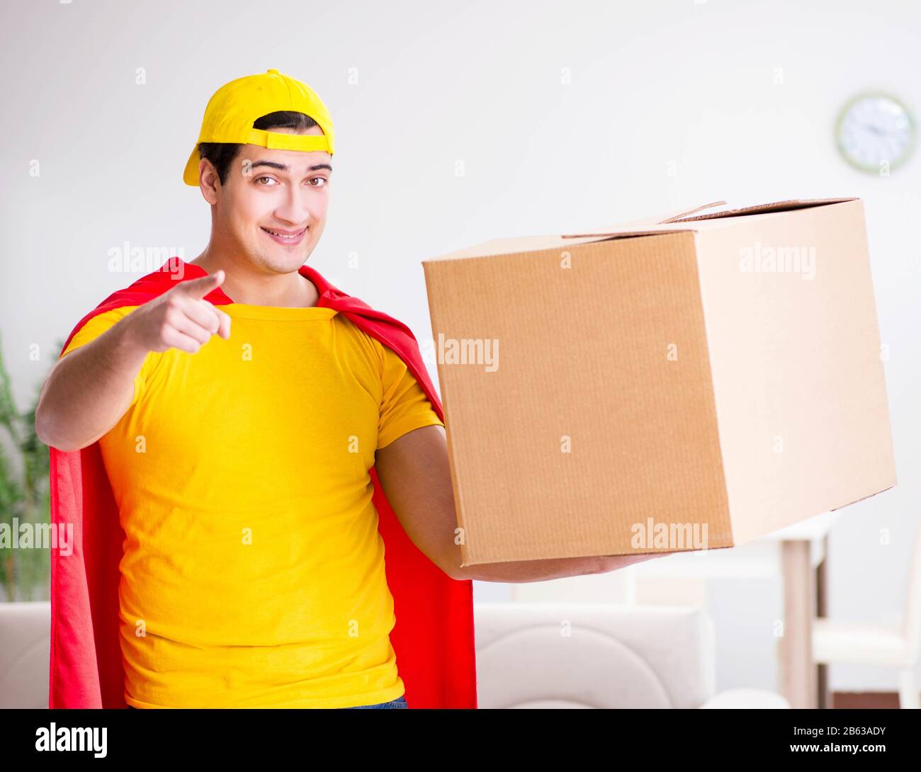 The superhero delivery guy with box Stock Photo - Alamy