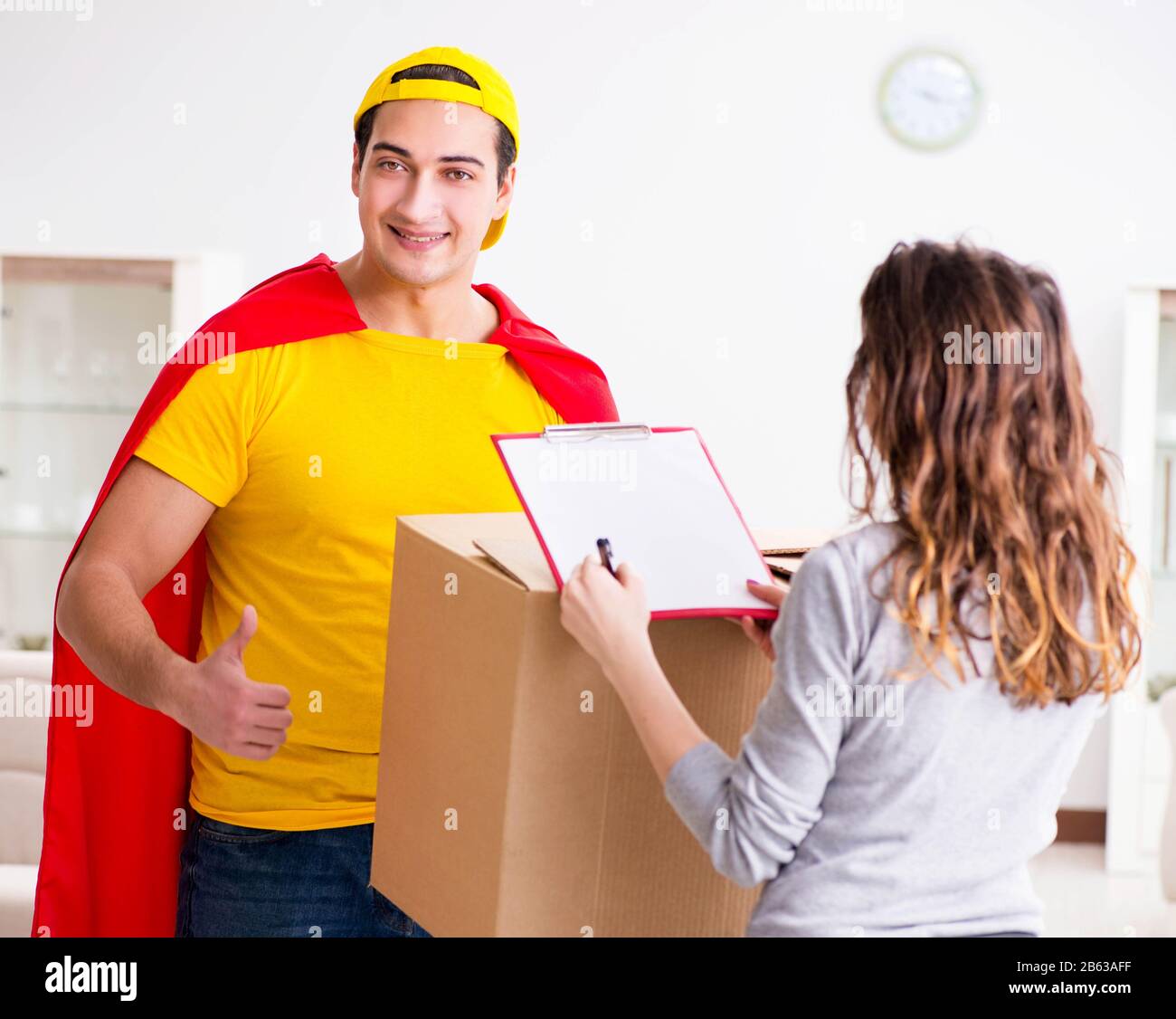 The superhero delivery guy with box Stock Photo - Alamy