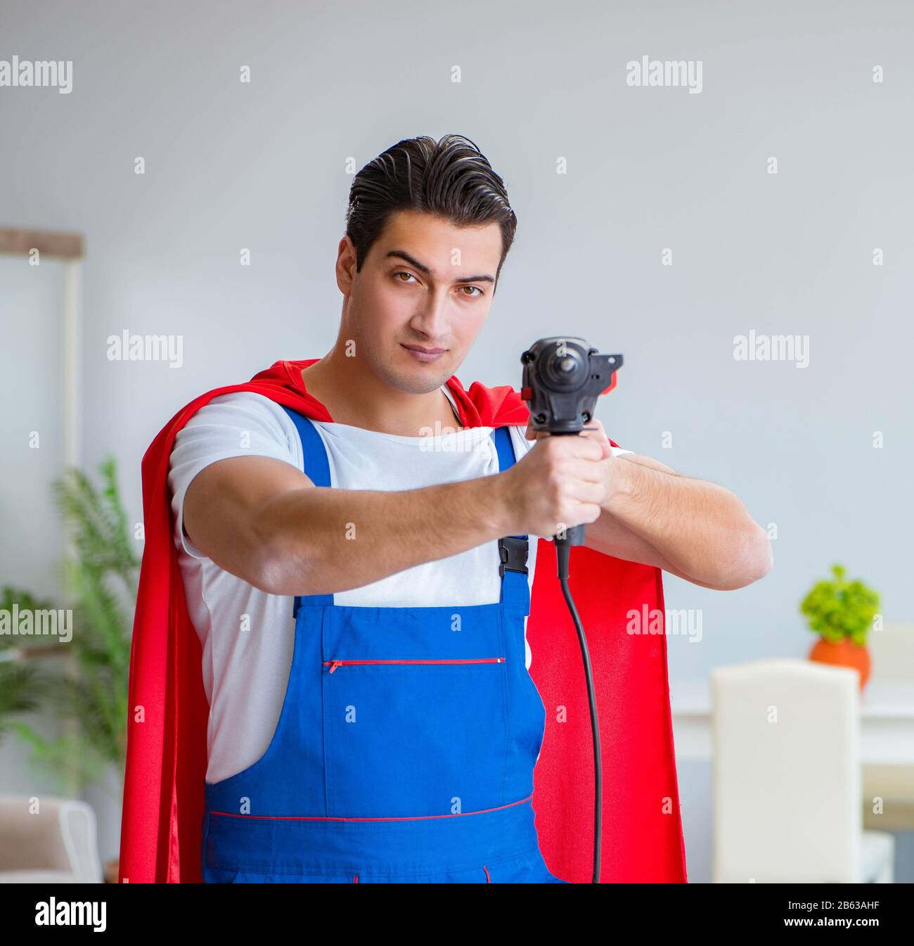 The super hero repairman working at home Stock Photo - Alamy