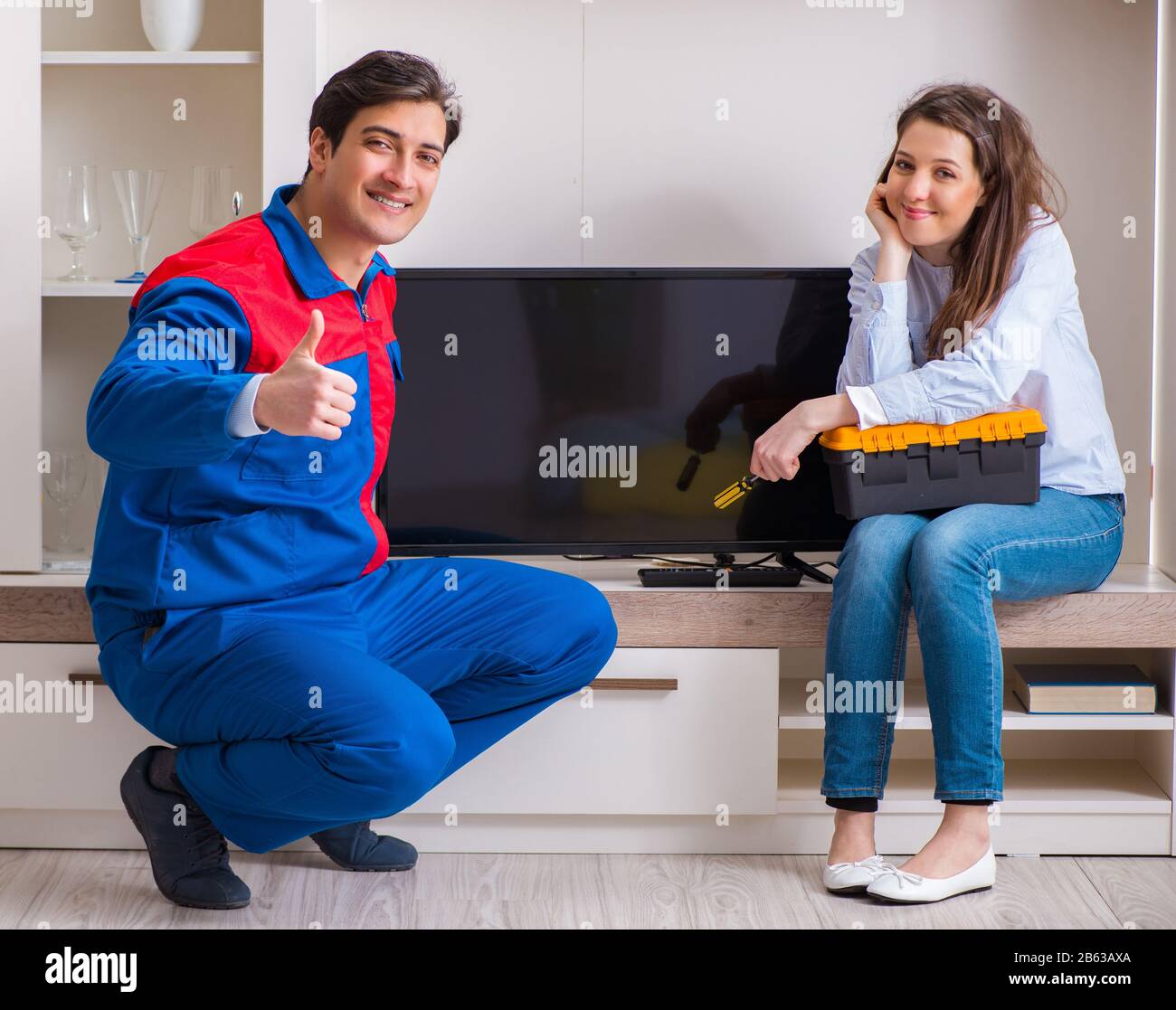 The repairman repairing tv at home Stock Photo - Alamy