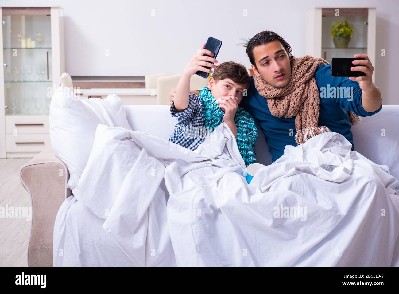 The young father caring for sick son Stock Photo - Alamy