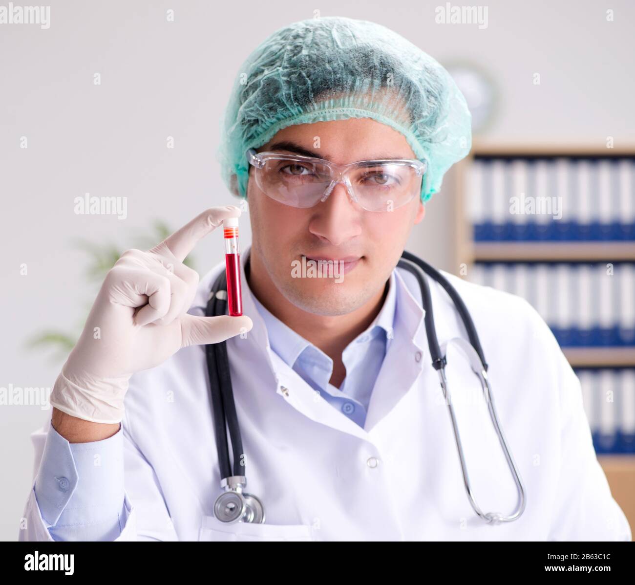 The young doctor working in the lab with microscope Stock Photo - Alamy