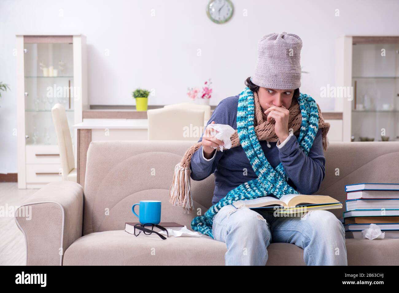 The sick male student suffering at home Stock Photo - Alamy