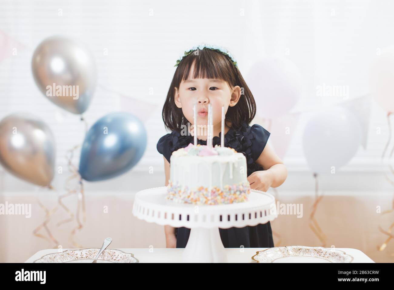 toddler girl celebrating her 4th birthday at home Stock Photo - Alamy