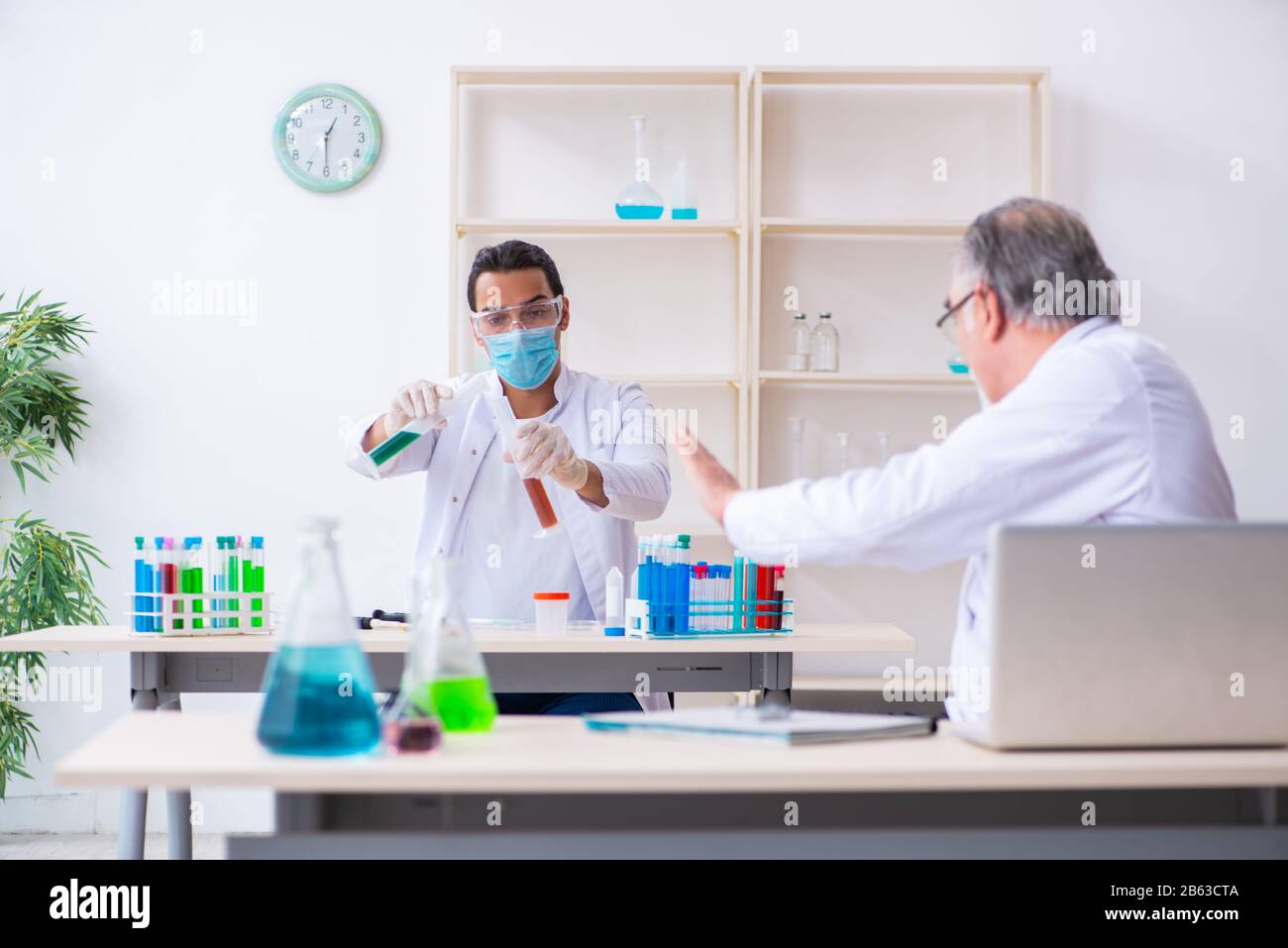 Chemist mix two liquid flask hi-res stock photography and images - Alamy
