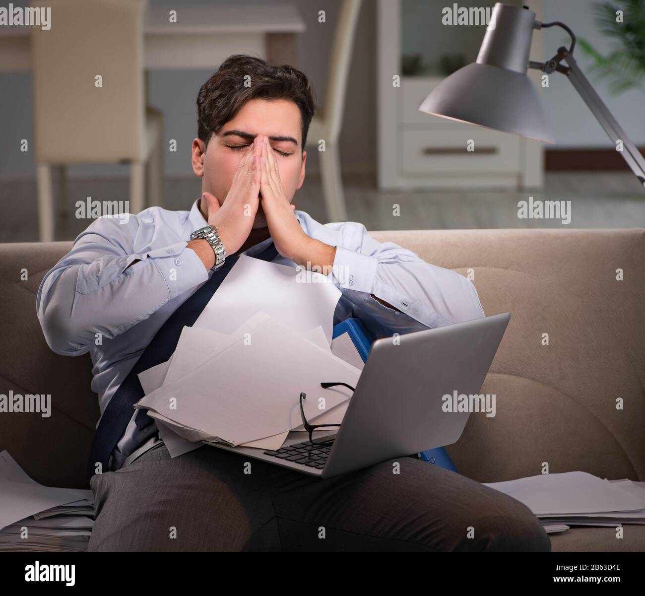 The businessman workaholic working late at home Stock Photo - Alamy