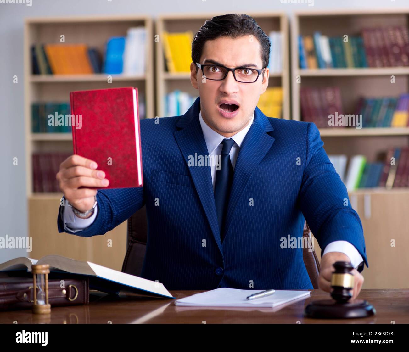 The handsome judge with gavel sitting in courtroom Stock Photo - Alamy