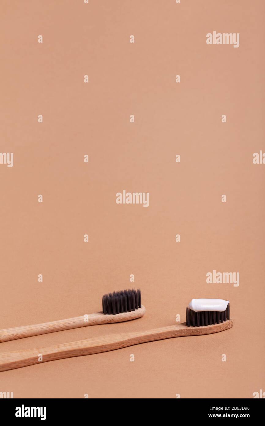 minimalistic neutral background with two wooden toothbrushes and a ...