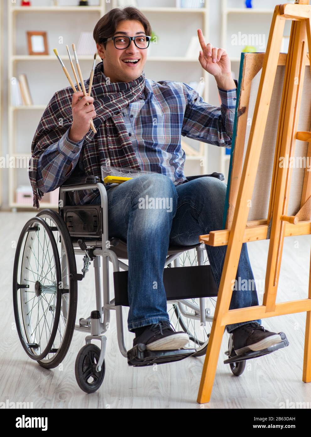 The disabled artist painting picture in studio Stock Photo - Alamy