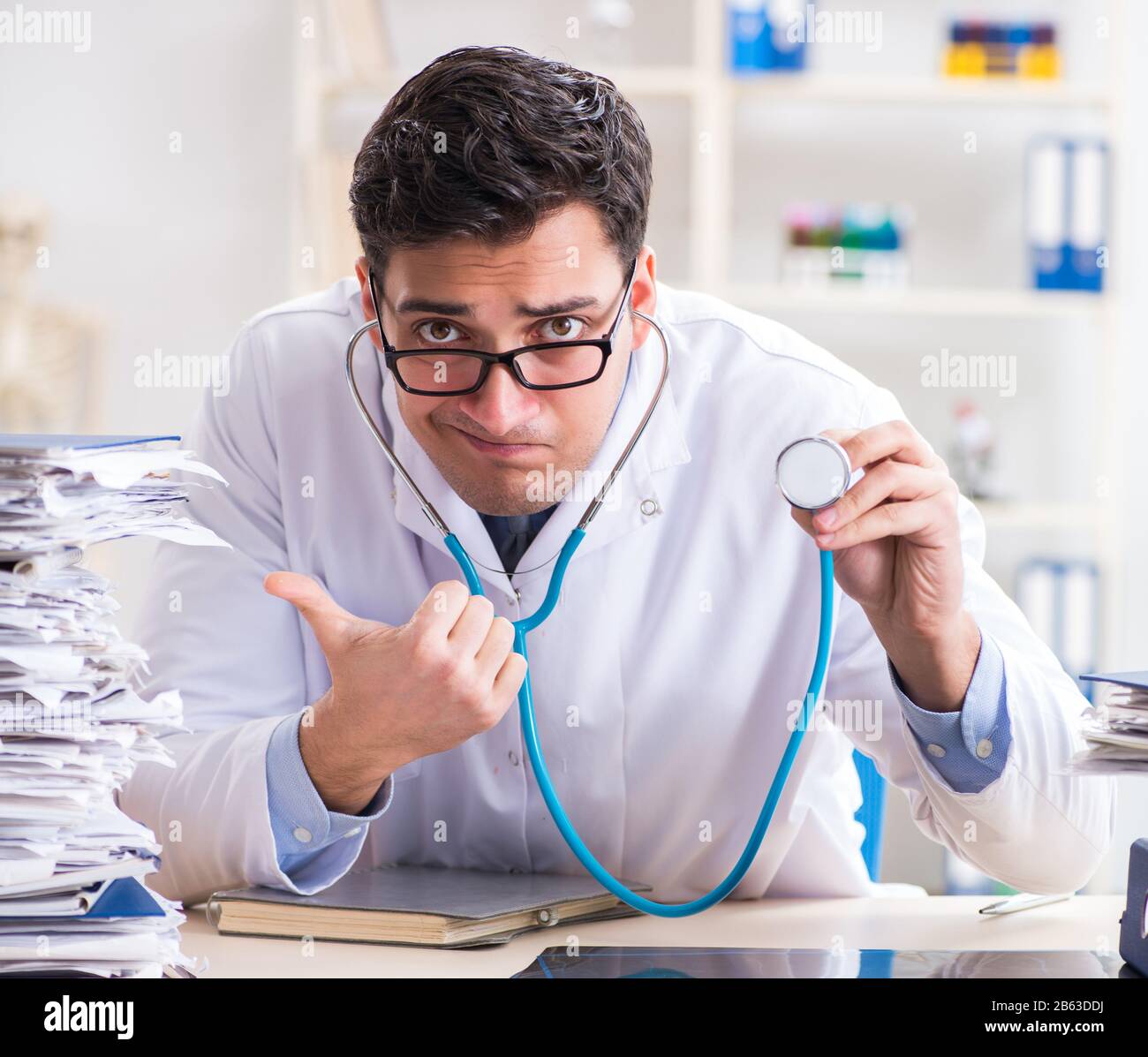 The busy doctor with too much work in hospital Stock Photo - Alamy