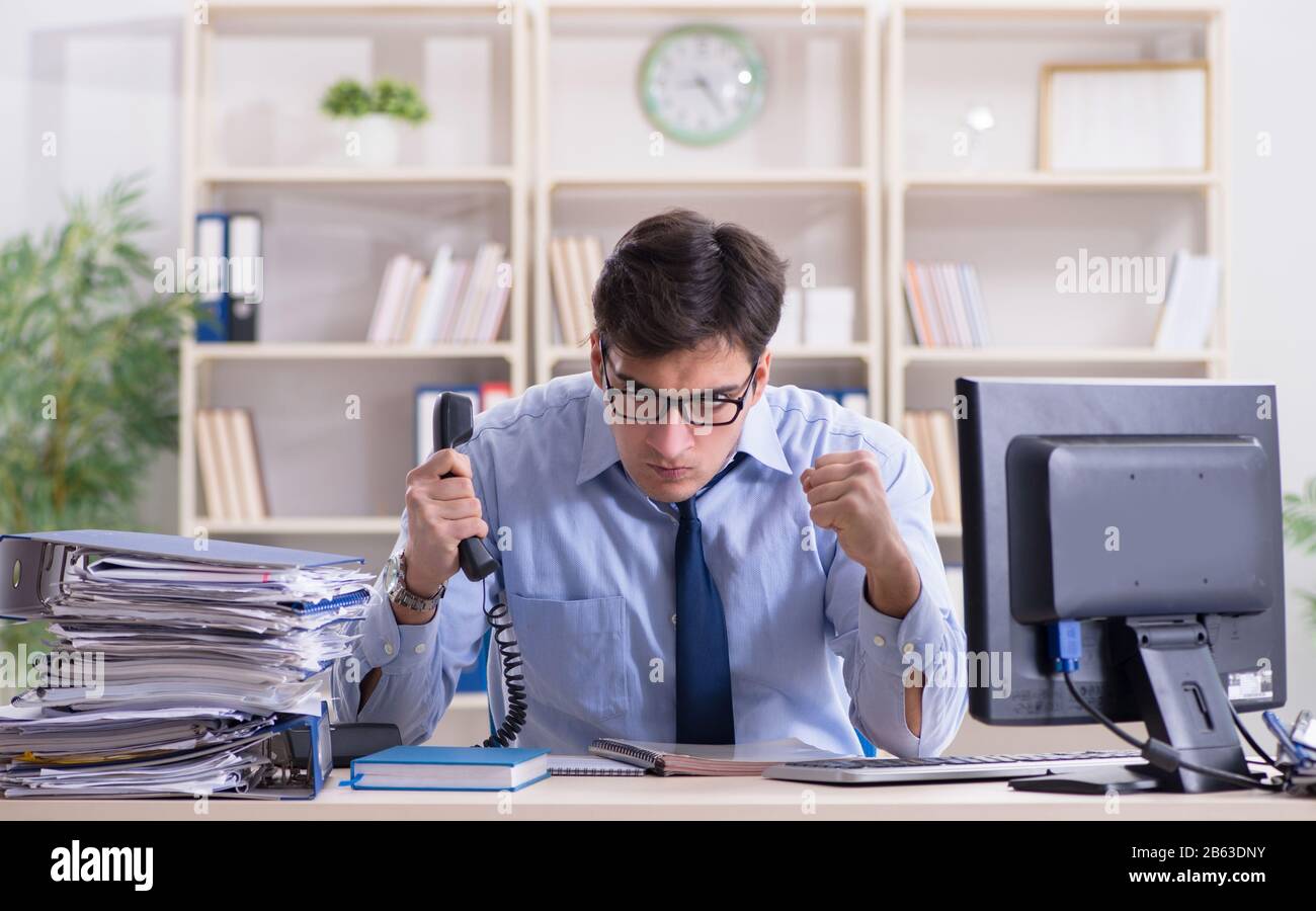 The angry businessman frustrated with too much work Stock Photo - Alamy