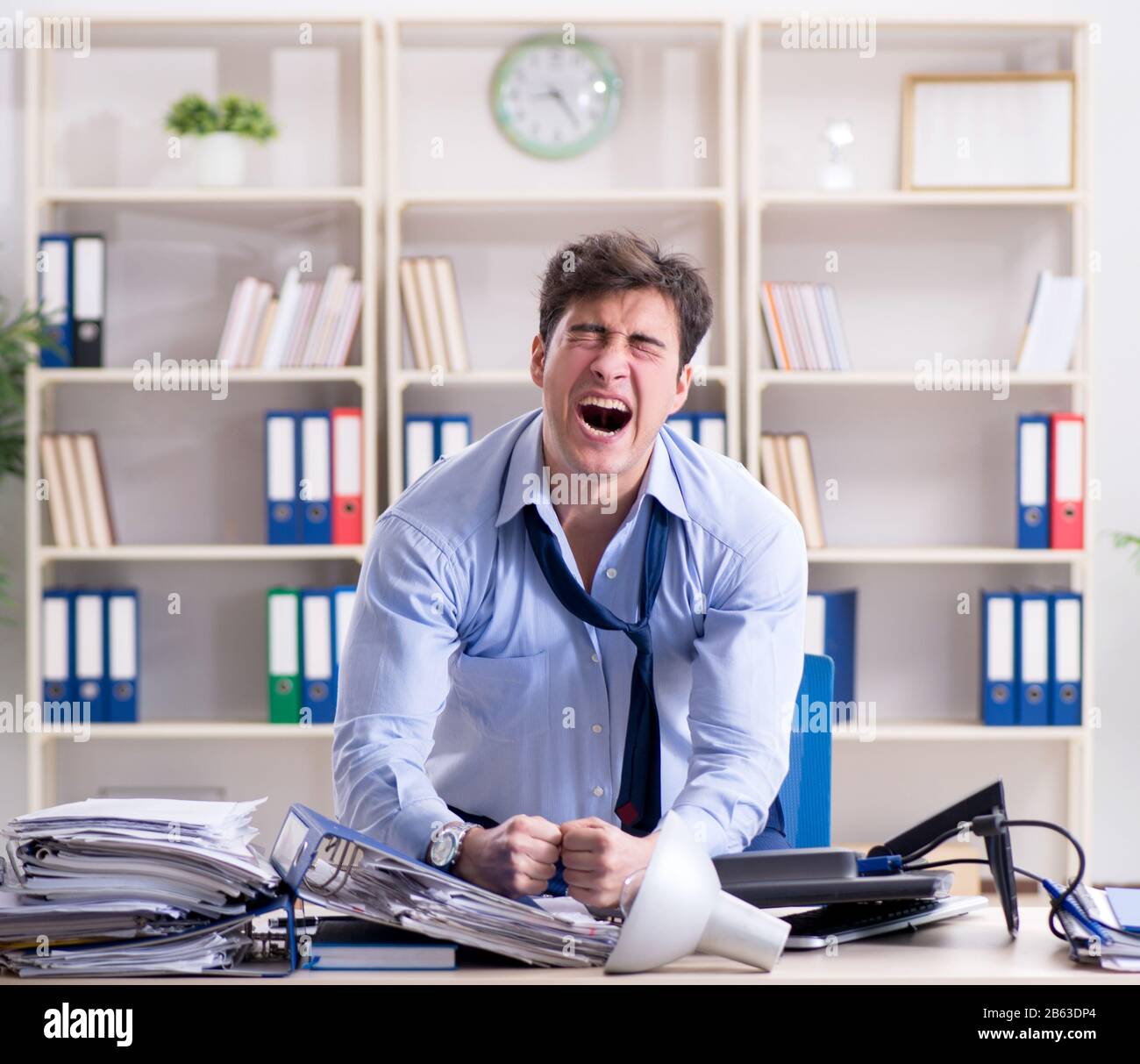 The angry businessman frustrated with too much work Stock Photo - Alamy