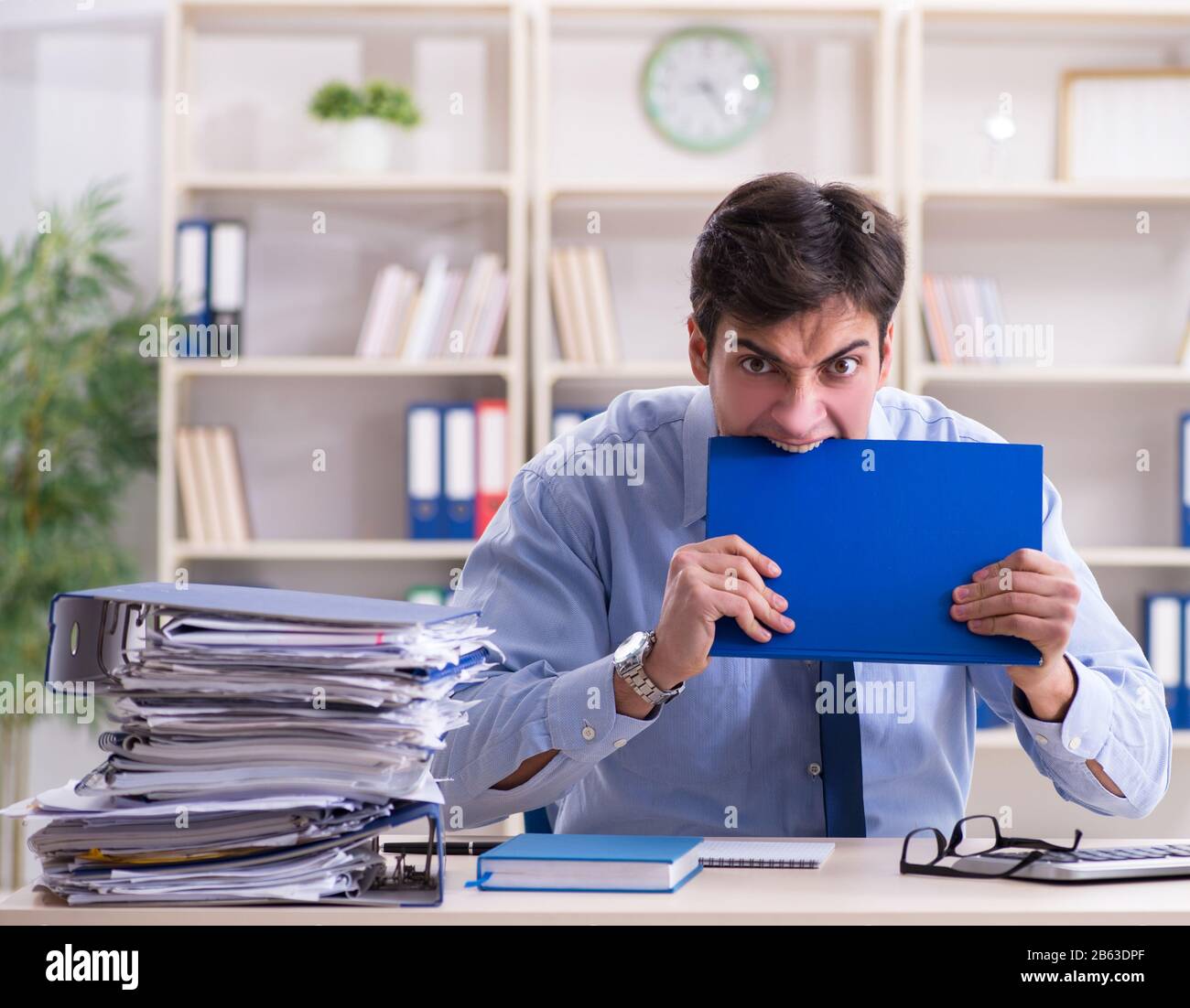 The tired businessman with too much paperwork Stock Photo - Alamy