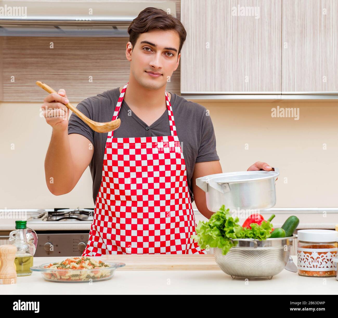 The man male cook preparing food in kitchen Stock Photo - Alamy