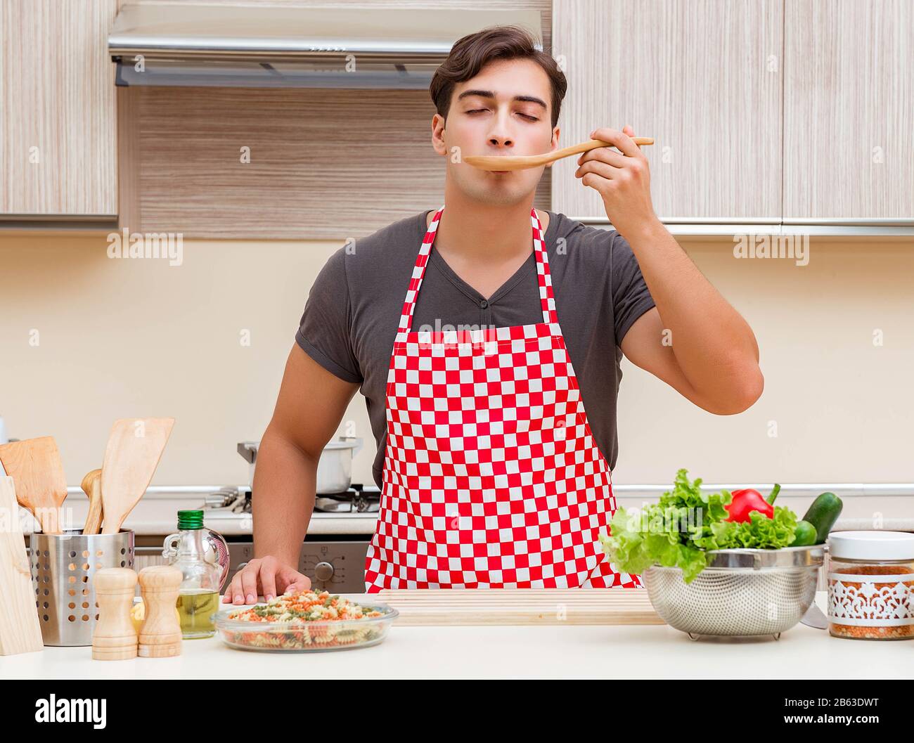 The man male cook preparing food in kitchen Stock Photo - Alamy
