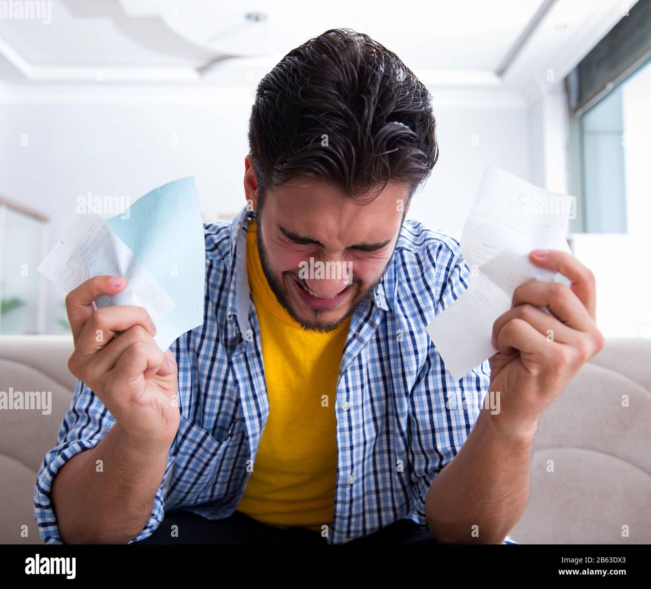The man angry at bills he needs to pay Stock Photo - Alamy