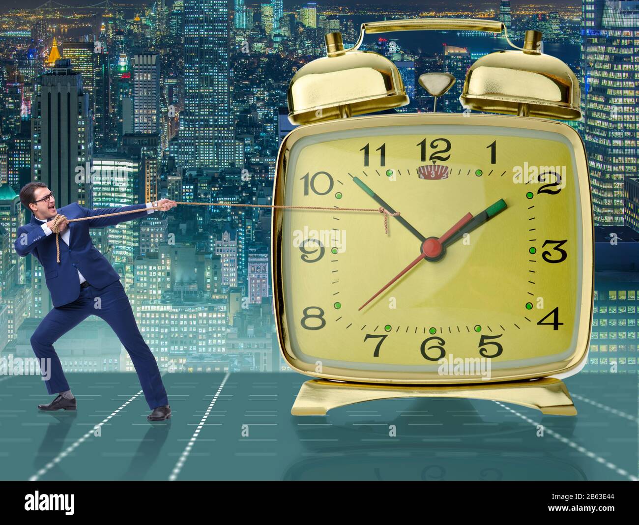 The businessman pulling clock in time management concept Stock Photo ...