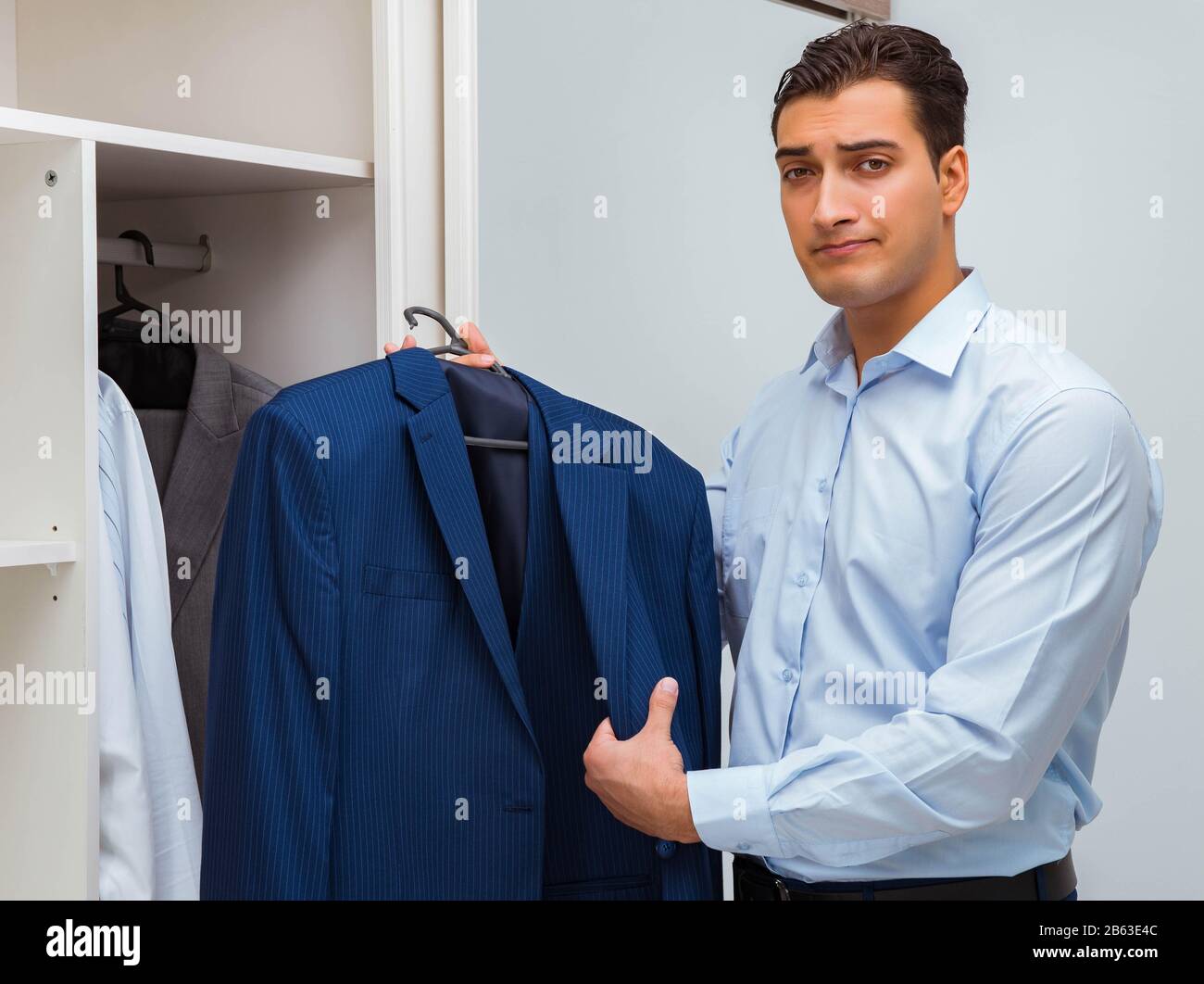 The businessman dressing up for work Stock Photo - Alamy