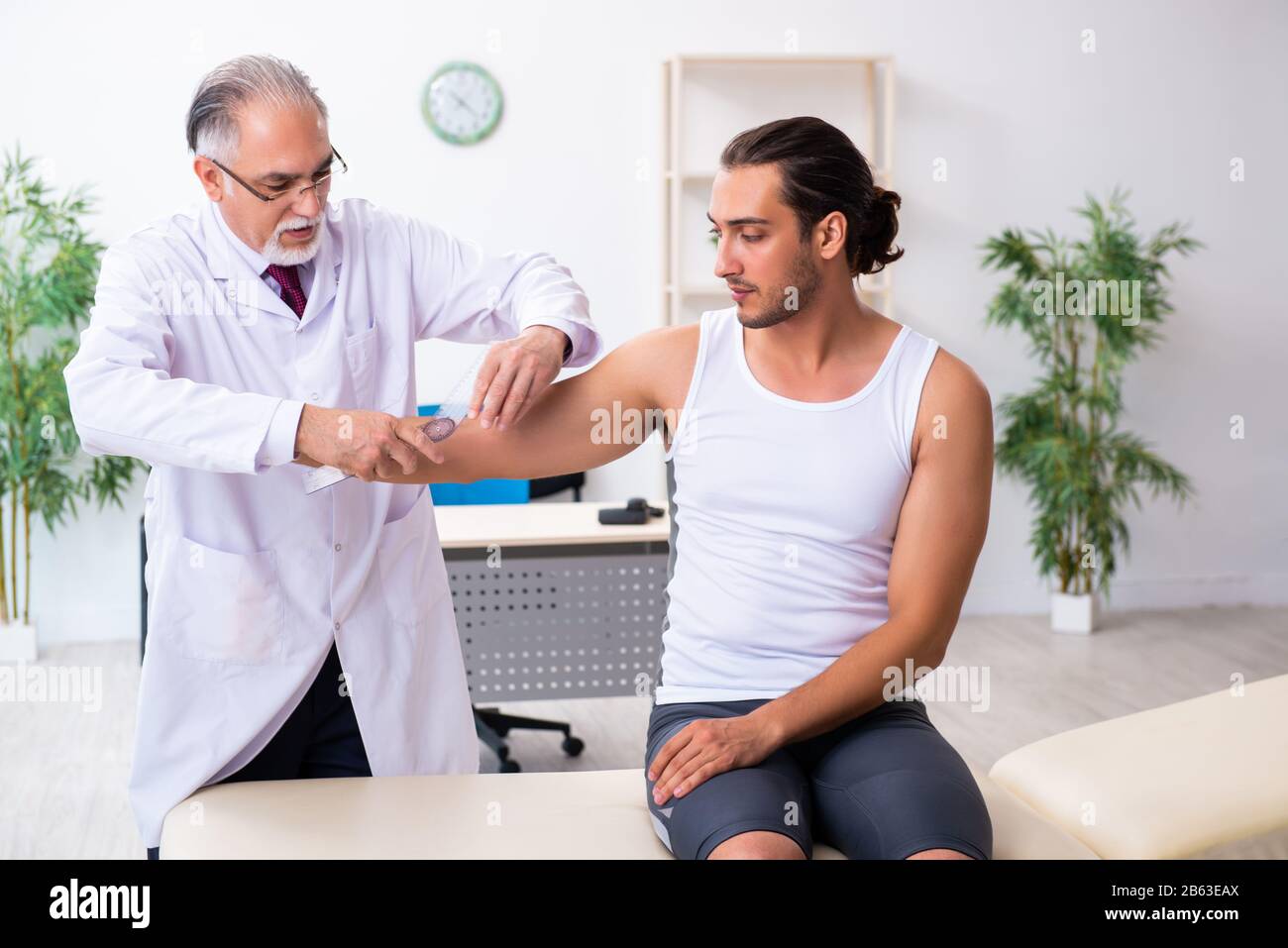 The young male patient visiting experienced doctor Stock Photo - Alamy
