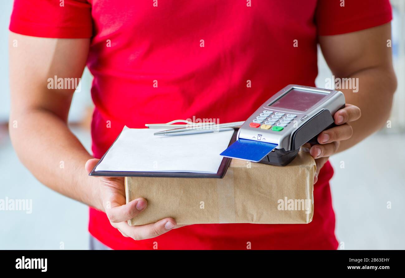 The parcel delivery being paid with pos and credit card Stock Photo - Alamy