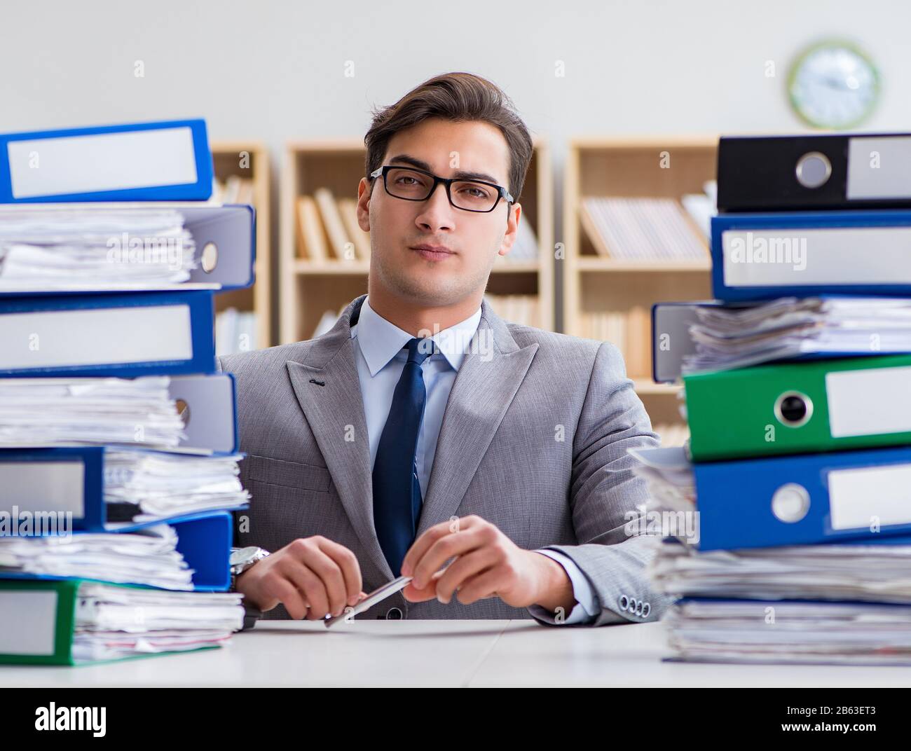 The busy businessman under stress due to excessive work Stock Photo - Alamy