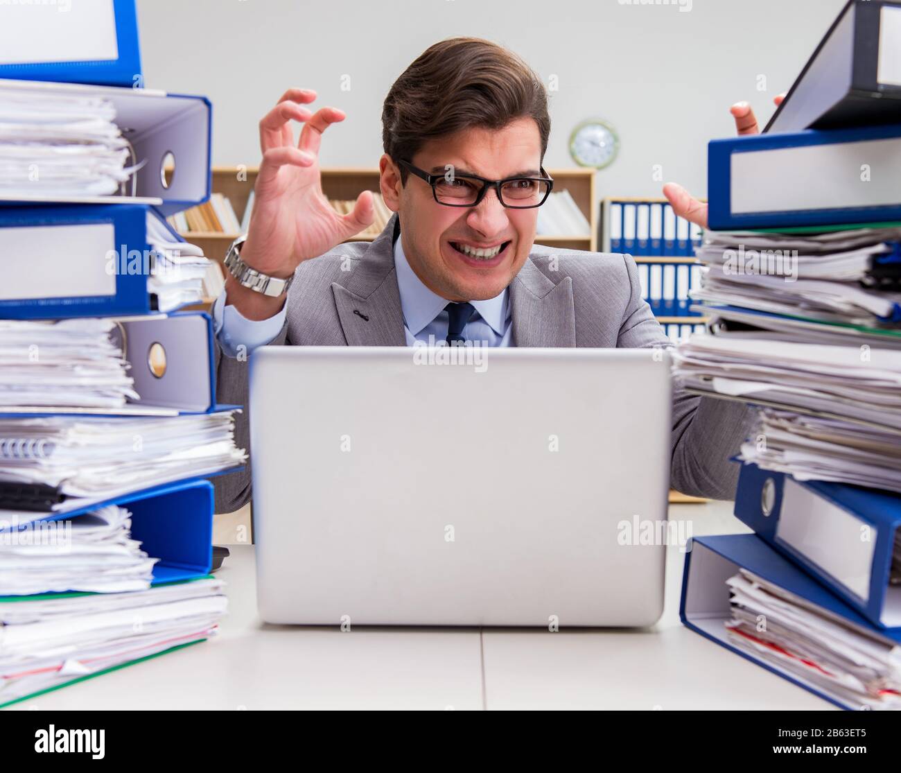 The busy businessman under stress due to excessive work Stock Photo - Alamy