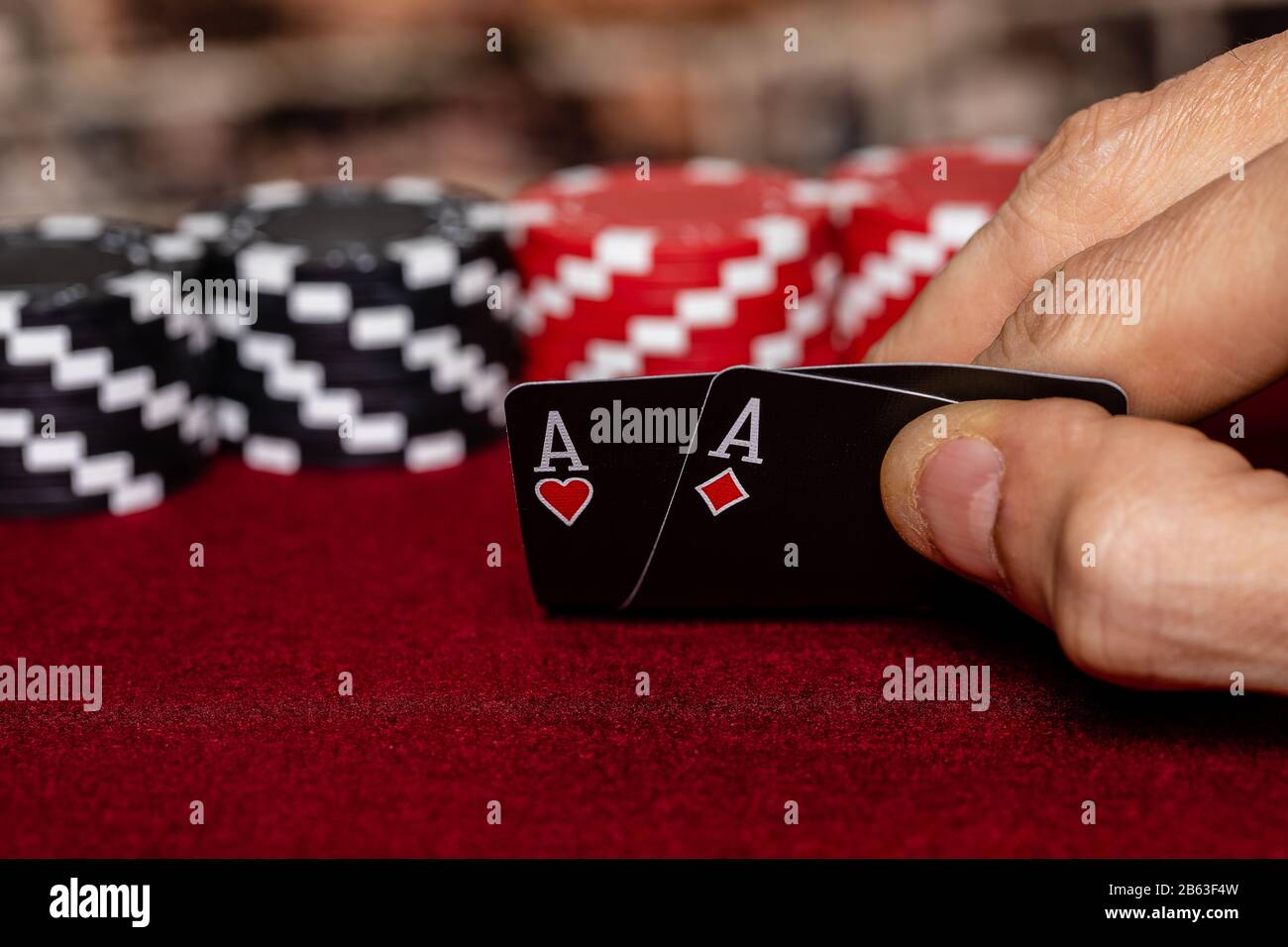 a male caucasian hand Showing a Pair of Aces in the hole, Hearts and ...