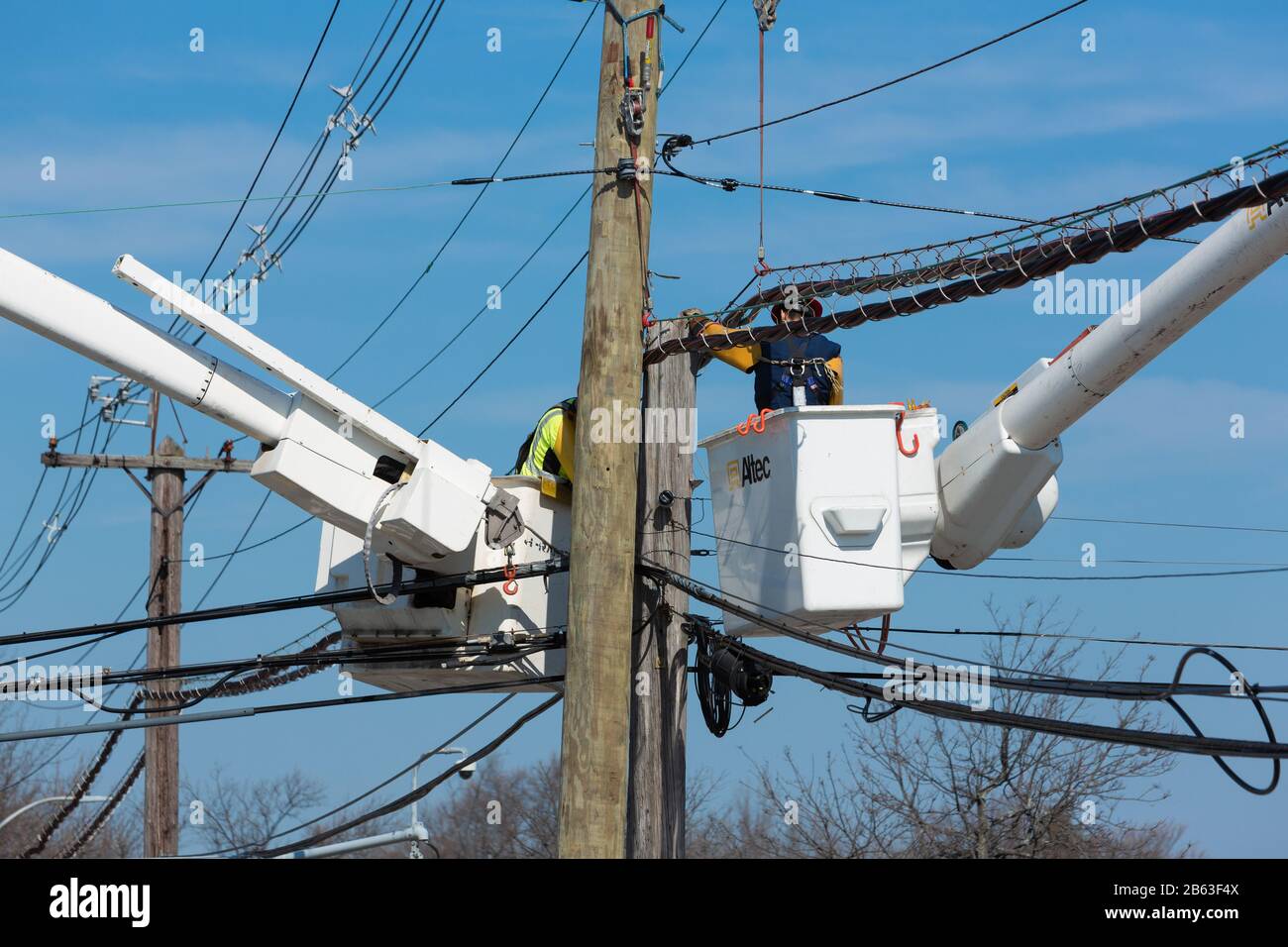 A sequence of images of a wooden electrical utility pole being replaced ...