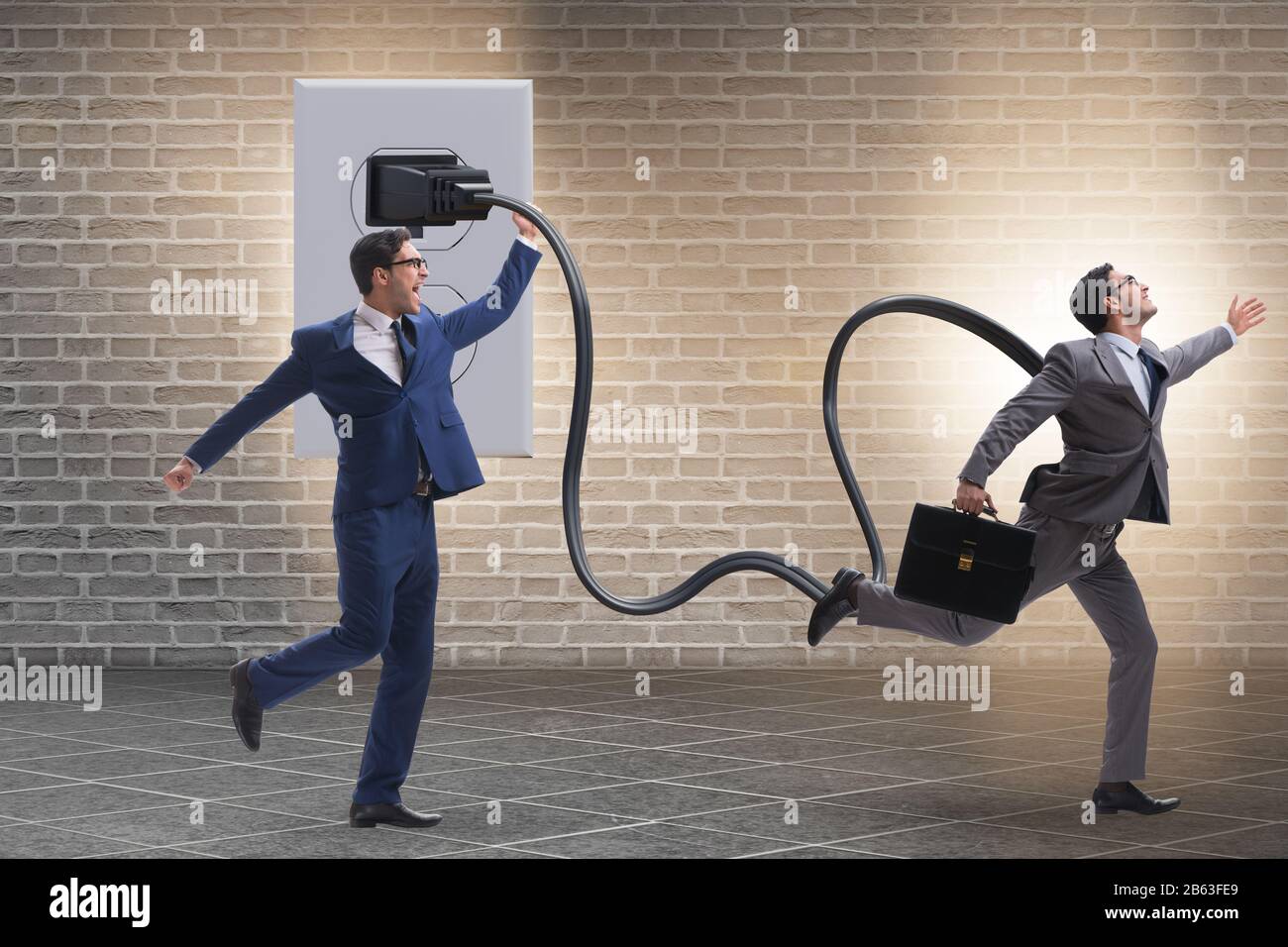 Businessman being powered by electricity and plug Stock Photo - Alamy
