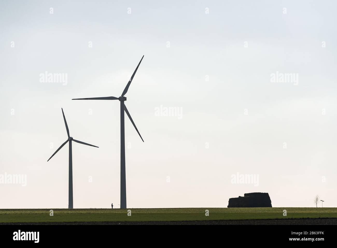 Two wind farms and a human silhouette showing the scale of windmill and ...