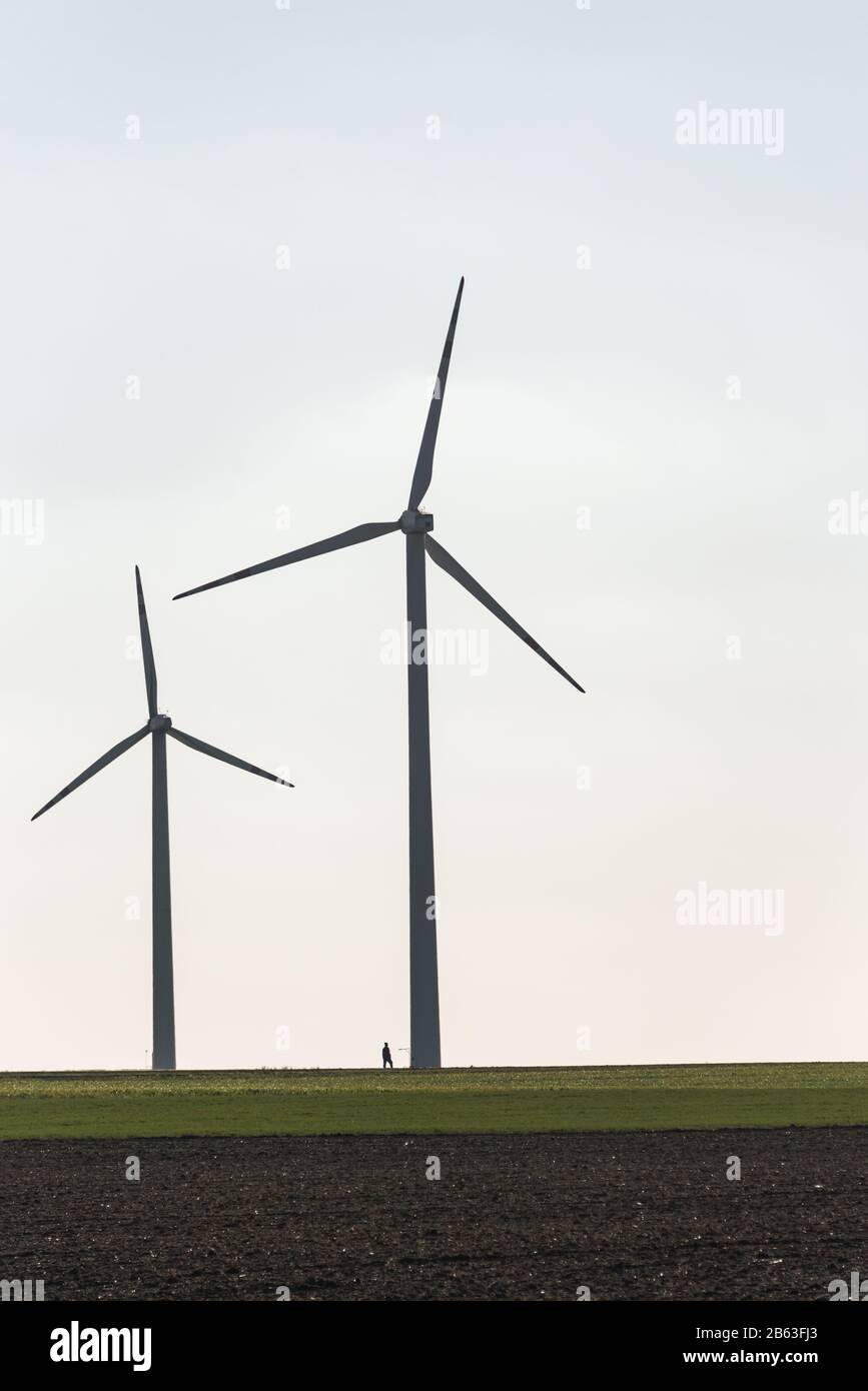 Two wind farms and a human silhouette showing the scale of windmill and ...