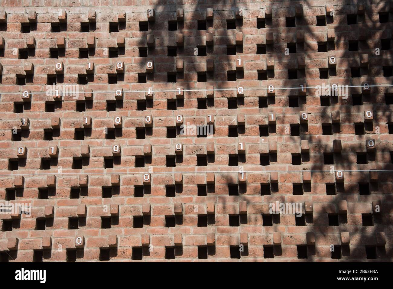 Numbered brick wall with 1 and 0 and small square openings Stock Photo ...