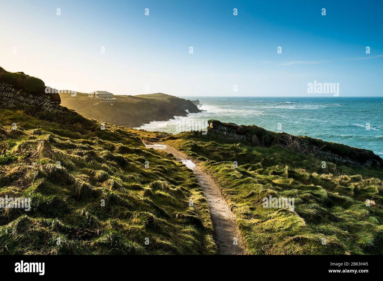 An old wall on the coast with Pentire Point East in the background in ...